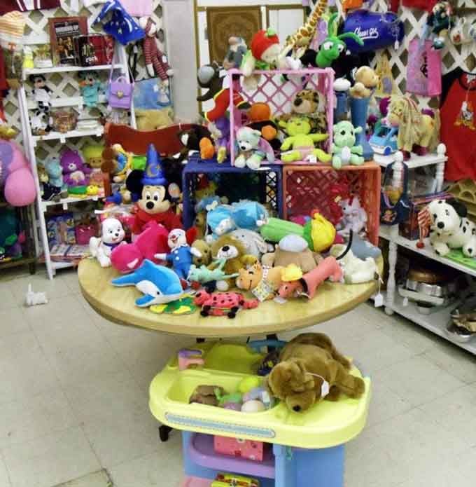 A colorful mountain of plush toys, including Sorcerer Mickey himself, ready to make someone's day considerably brighter.