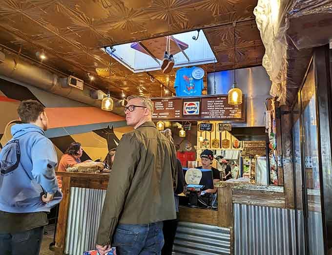 The ordering counter where dreams of giant pizza slices become your cheesy, saucy reality.