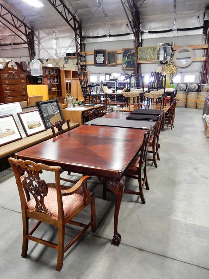 A long mahogany dining table with carved chairs, the kind of furniture that anchors a room beautifully.