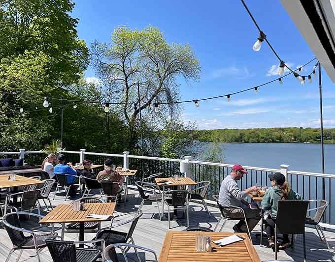 Waterfront patio dining with string lights overhead transforms any meal into a lakeside celebration worth savoring.