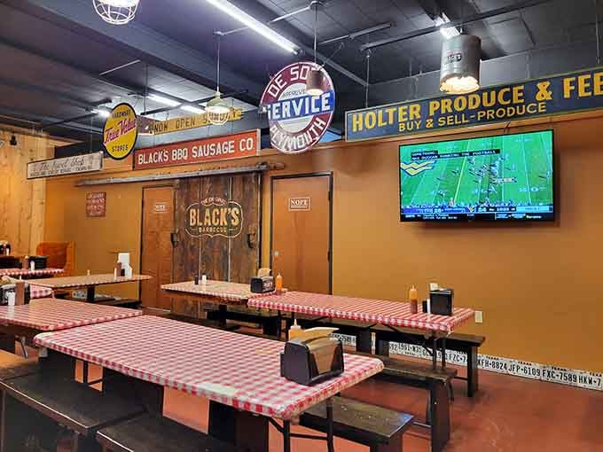 Checkered tablecloths, a football game on the TV, and vintage signs overhead, this dining room is exactly where you want to be.