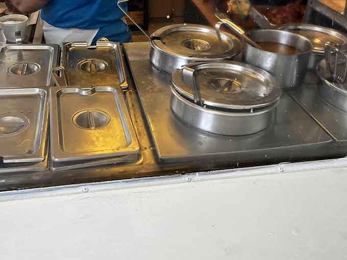 Stainless steel warmers lined up and ready for service. Behind those lids, something slow-cooked and deeply satisfying is patiently waiting just for you.