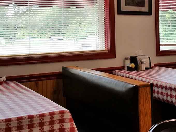 A leather booth, a sunlit window, and a red and white tablecloth. This is the seat you didn't know you needed today.