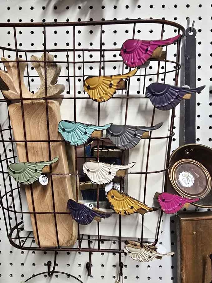 Colorful cast metal bird clips perched on a wire rack, cheerful little things that somehow make you smile without trying at all.