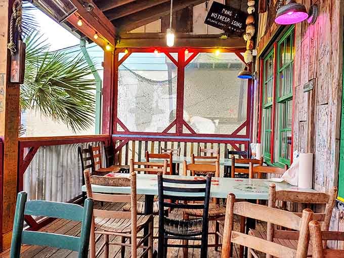 Mismatched chairs, fishing nets on the walls, and fresh air coming through. This porch table is the best seat in the house.