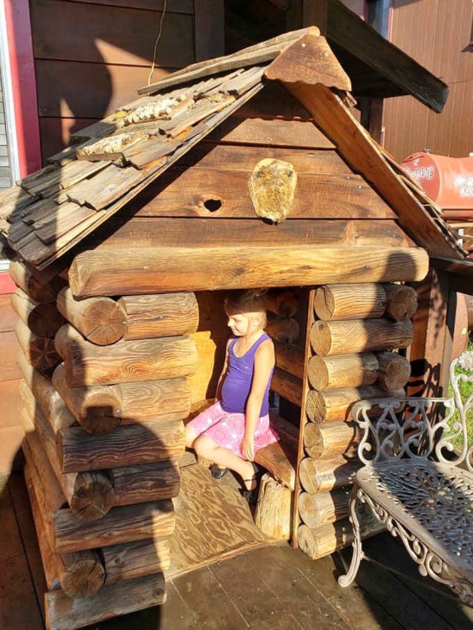 A handcrafted log cabin playhouse outside. Because Buffalo Chip's thinks of absolutely everyone in the family.