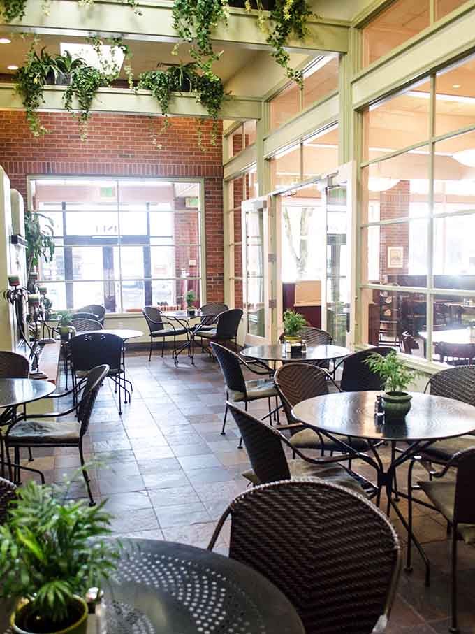 The garden room brings the outdoors in with hanging plants and natural light that makes every meal feel special.