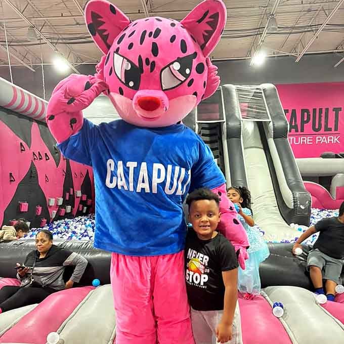 Meet the park's official greeter, a pink mascot with serious energy and zero plans to calm down.