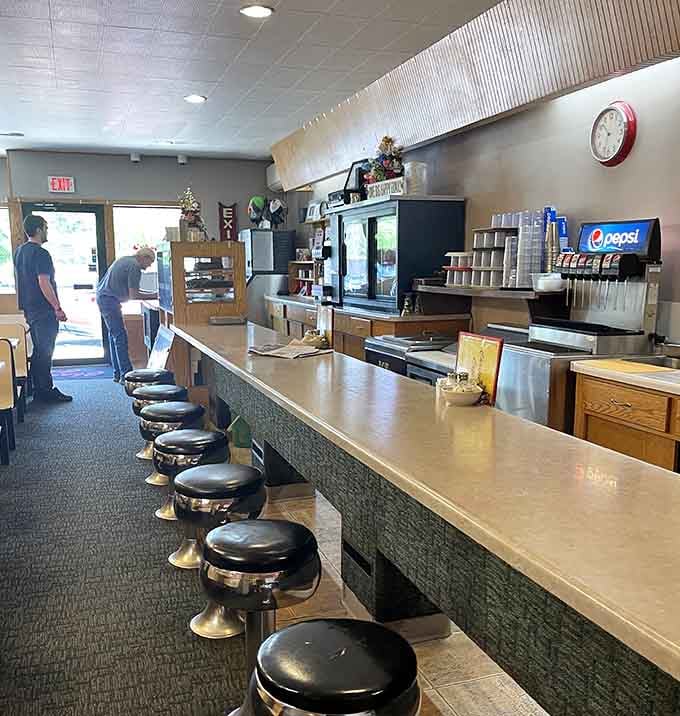 A classic diner counter with round stools that practically beg you to sit down and order something good.