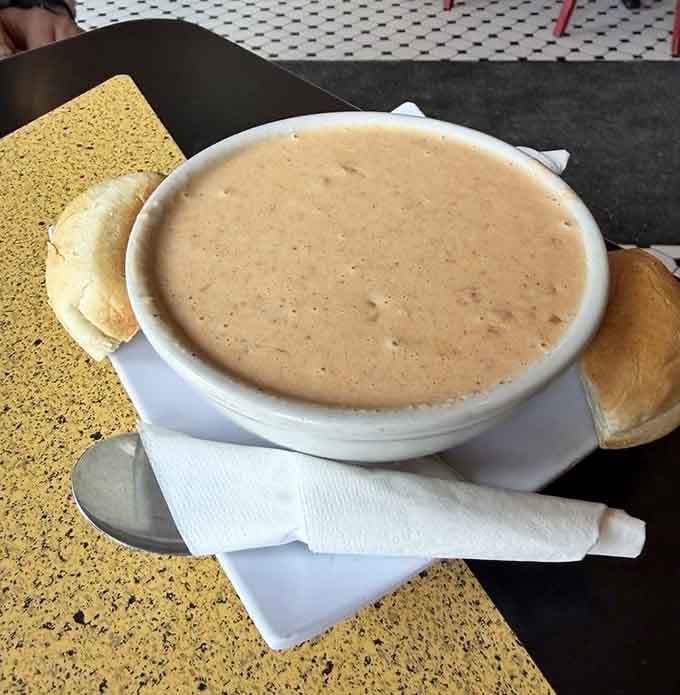 A bowl of lobster bisque served with bread on the side &mdash; rich, smooth, and completely unexpected in the most delightful way.