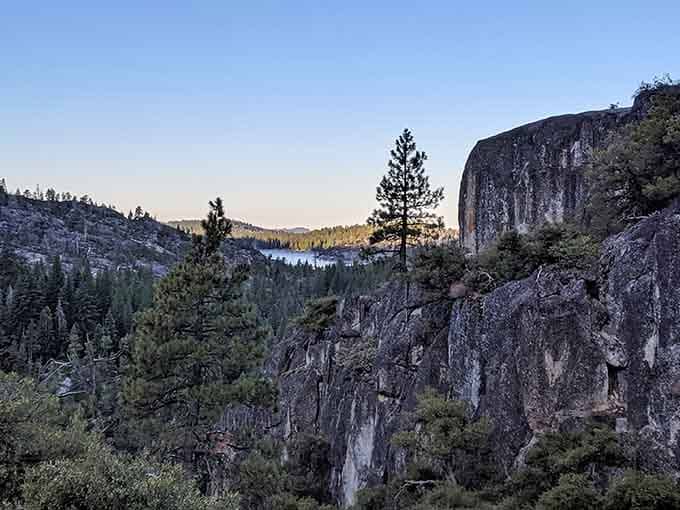 Dramatic granite cliffs tower above the landscape, reminding you that geology is basically nature showing off its sculpting skills.