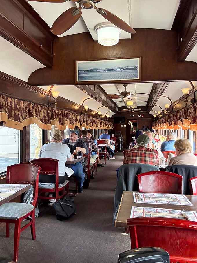 Dark wood, ceiling fans, and vintage photos. Eating inside this 1920s train car feels like dining inside history itself.