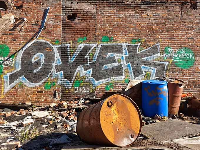 Rusted barrels and crumbling brick create an aesthetic that interior designers charge thousands to replicate artificially.