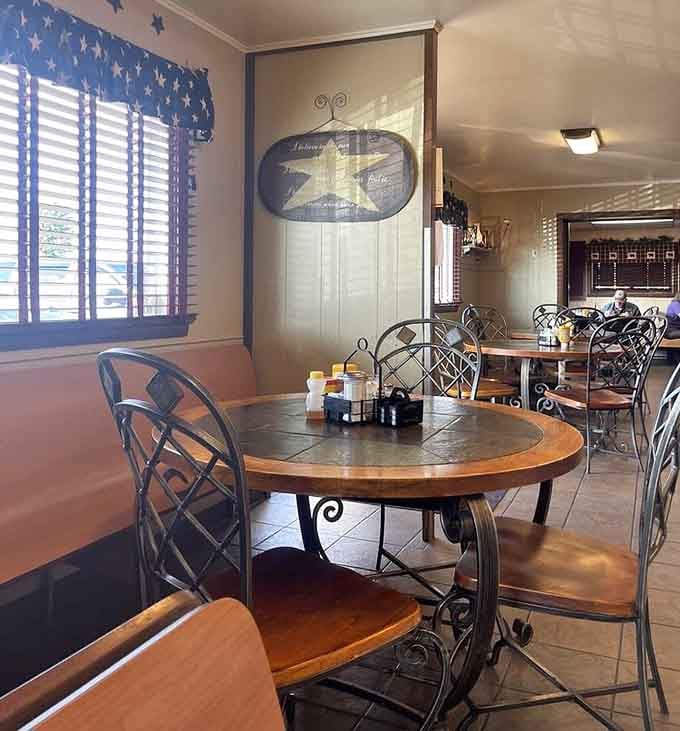 Wrought iron chairs, star-themed curtains, and warm light. This dining room feels like somebody's favorite aunt decorated it.