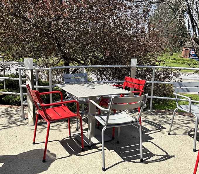 Outdoor seating with red chairs and fresh air. A great breakfast tastes even better with a view.