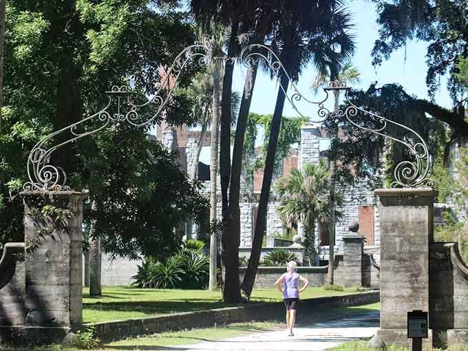 One visitor pauses beneath those sweeping iron gates, and you completely understand why she stopped there.