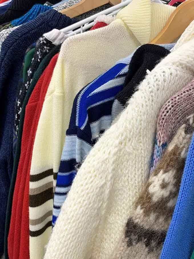 Racks of vintage knit sweaters in bold stripes and cozy textures, ready to make your wardrobe considerably more interesting.