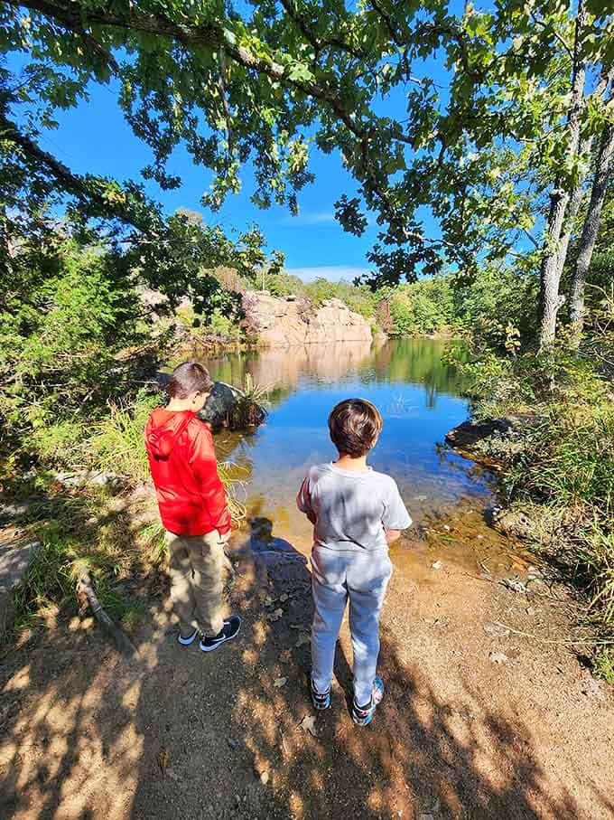 Two kids, one stunning quarry pond, zero screens. This is what childhood memories are actually made of.