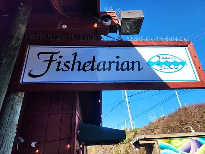 The Fishetarian Fish Market sign hangs proudly against a brilliant blue sky. Small sign, enormous reputation, completely justified.