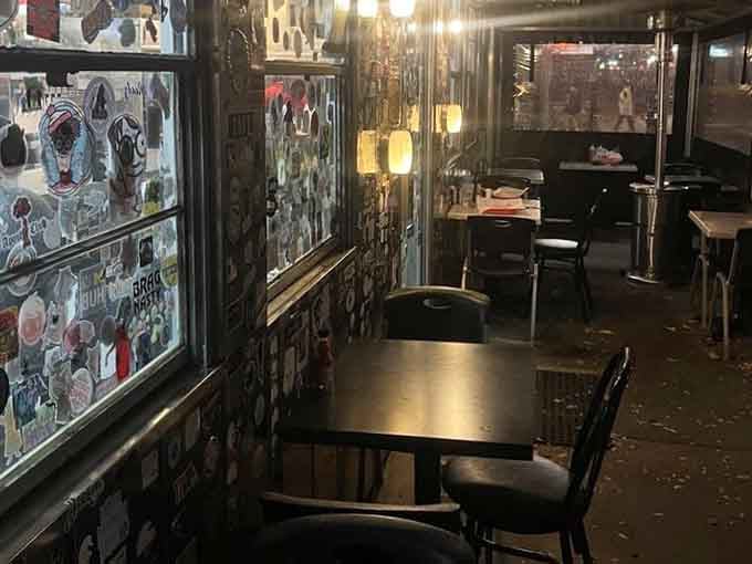 Warm lamplight, sticker-covered windows, and dark tables waiting for the next round of hungry visitors. Pure diner magic after dark.