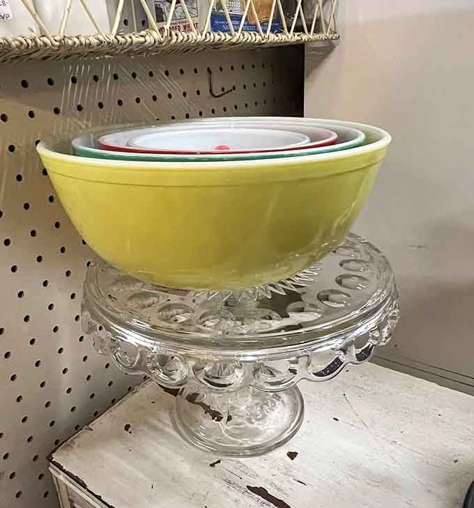 Nesting bowls in cheerful colors perched on glass, proving kitchenware can be both functional and absolutely delightful.