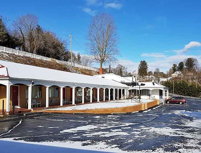 Snow dusting the parking lot and that distinctive curved architecture create an unexpectedly charming winter mountain scene.