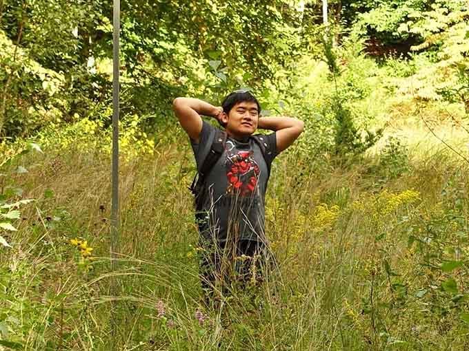Even a visitor ends up looking relaxed and content here, surrounded by tall grasses and golden late-summer wildflowers stretching in every direction.