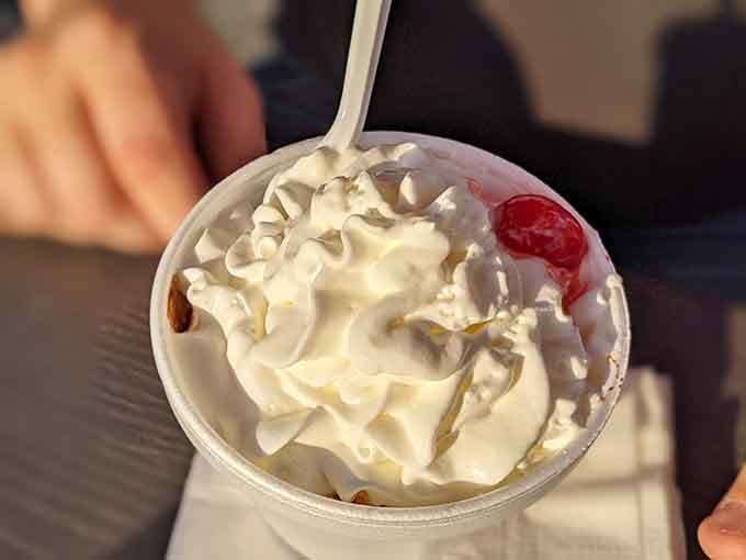 That ice cream sundae topped with whipped cream and a cherry is the perfect sweet ending to your savory adventure.