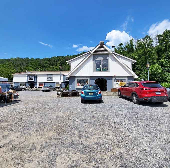 A gravel lot surrounded by green hills and blue sky. Even the parking lot here has good bones.