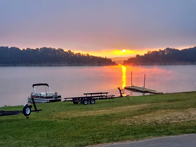 Sunrise over the lake with a pontoon boat ready to go, which is honestly a better alarm clock than anything on your phone.