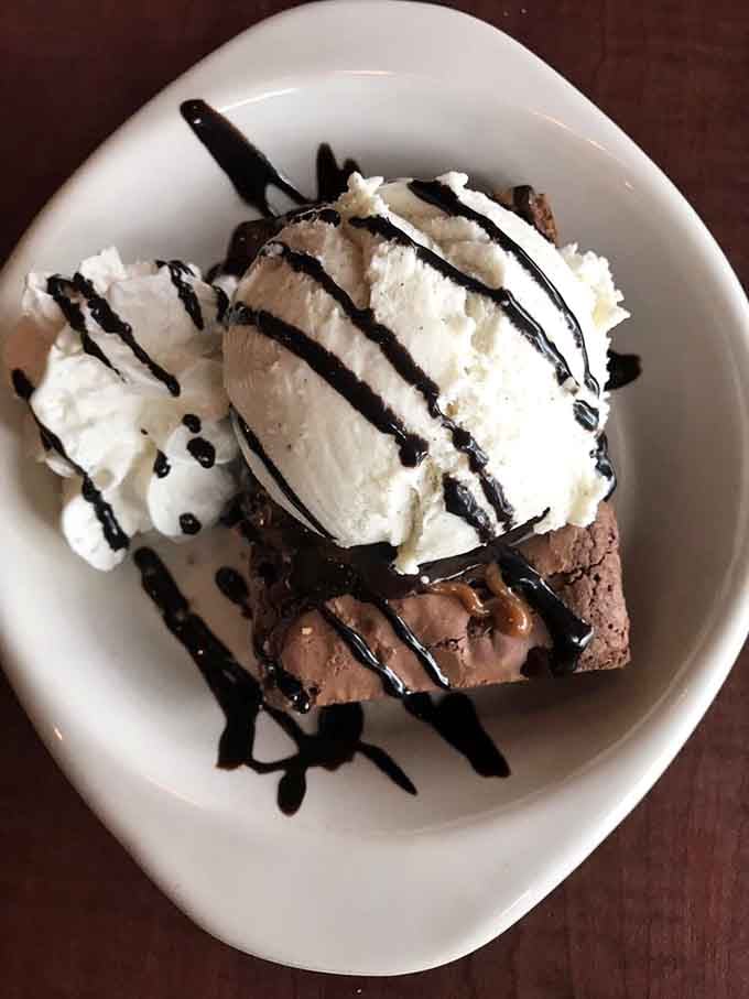 A brownie topped with ice cream and chocolate drizzle. Because every great breakfast spot deserves an equally great ending.
