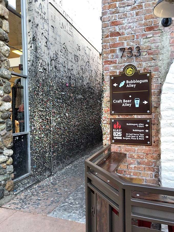 The entrance to Bubblegum Alley on Higuera Street, where the directional sign and the gum wall greet you like old, slightly weird friends.