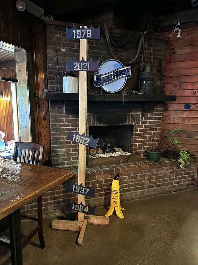 A brick fireplace adds rustic charm and warmth, making this spot feel like a favorite neighbor's well-loved gathering place.