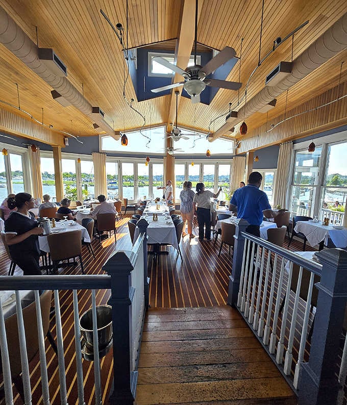 Warm wood ceilings, harbor views through every window, and a dining room humming with the quiet joy of a great meal.