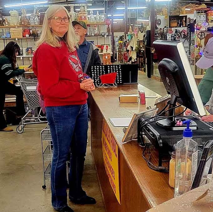 The checkout counter, where happy shoppers arrive clutching their finds with the satisfied grin of seasoned treasure hunters.