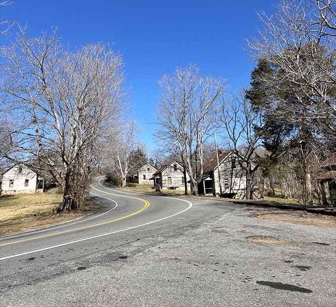 The road curves right through history, with weathered cottages lining both sides like silent sentinels.