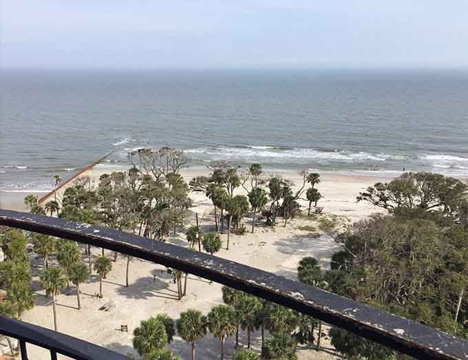 From the top of the lighthouse, the beach below looks like a postcard that somehow got even better in person.