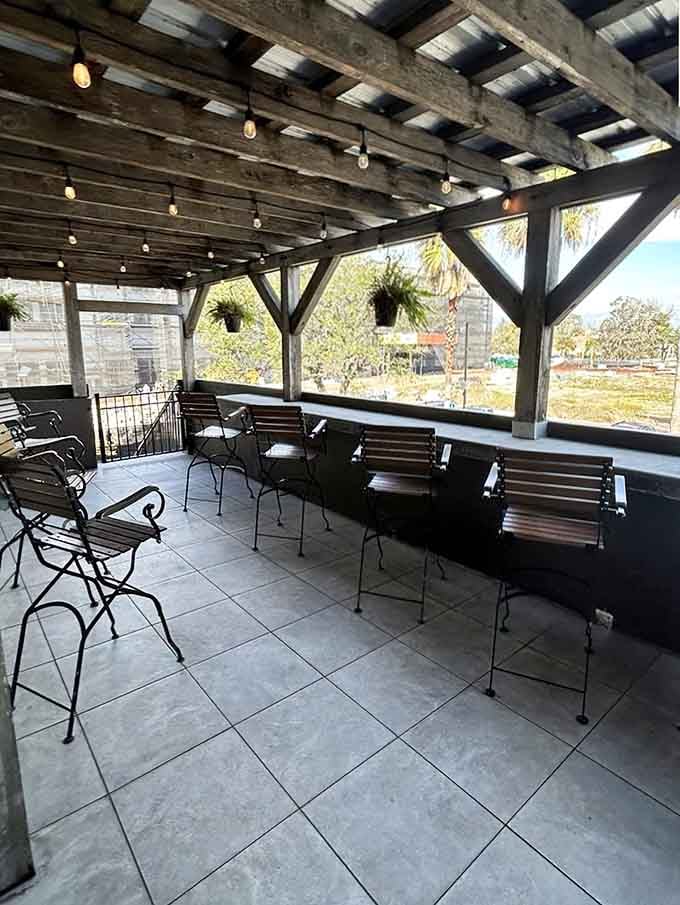 An upstairs patio with string lights, open beams, and a view that makes you want to stay until the stars come out.