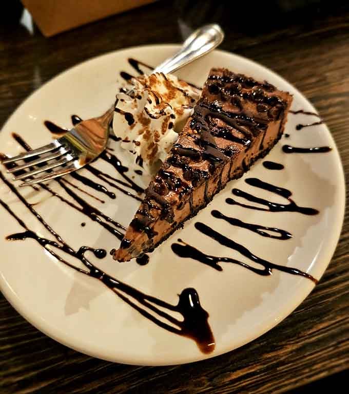 Chocolate cheesecake drizzled with dark chocolate sauce. One slice in and you'll completely forget what you ordered for dinner.
