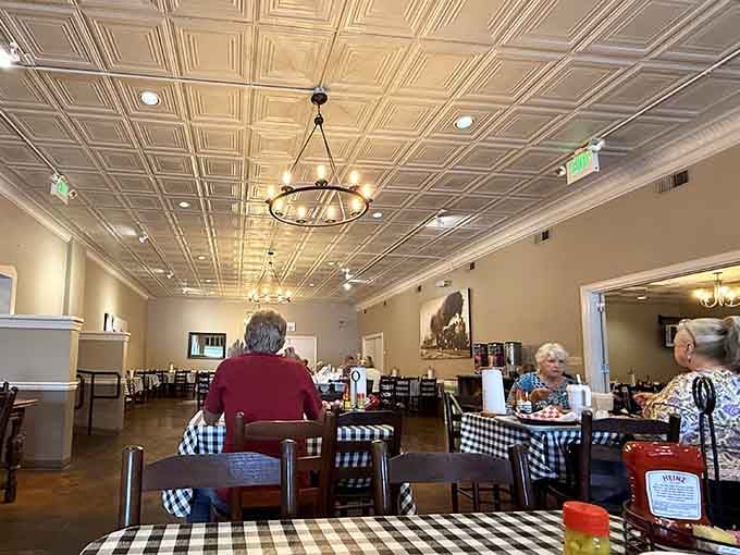 The tin ceiling glows under the chandelier light while diners settle in, proof that the best meals are always worth slowing down for.