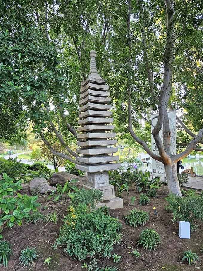 A multi-tiered stone pagoda rising through the trees, patient and dignified, like it's been waiting for you to notice it all along.