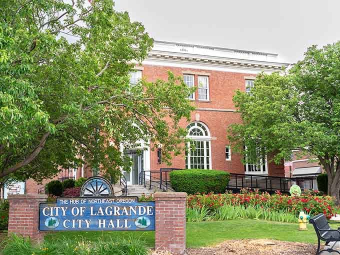 La Grande City Hall sits beneath summer trees, looking exactly like civic pride is supposed to look.
