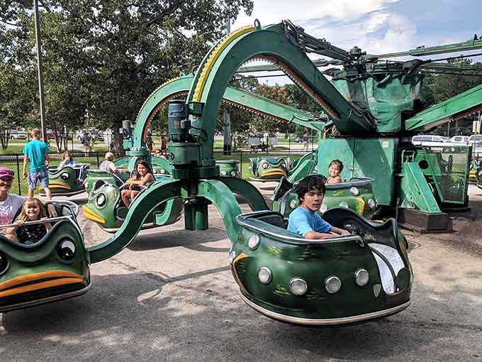 Those frog-faced cars spinning and dipping on mechanical arms look like something dreamed up by a very cheerful engineer.