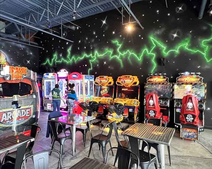 Green lightning bolts crackling across a starry black ceiling, with racing games lined up below, this arcade section has serious atmosphere.