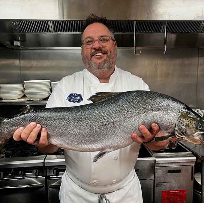 When your chef grins like that holding a whole rainbow trout, you know tonight's fish dish is going to be extraordinary.