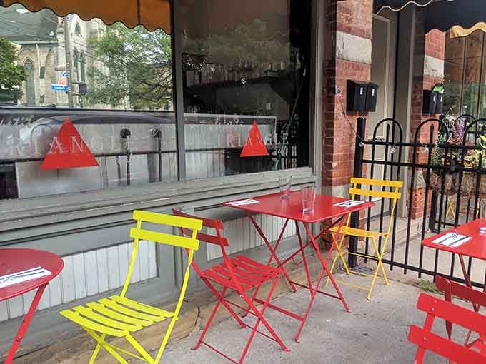 These cheerful bistro tables prove that happiness comes in red and yellow, preferably with croissants nearby.