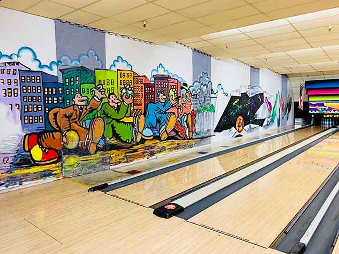 Whimsical murals featuring cartoon bowlers add personality and charm to every frame you throw here.