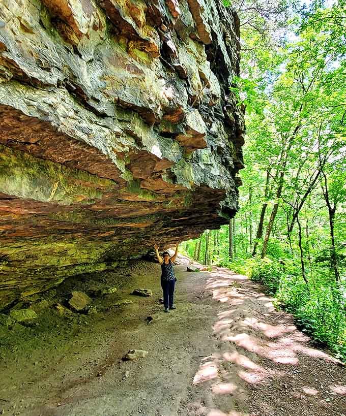 Standing under a massive rock overhang, feeling both tiny and completely thrilled about it at the same time.