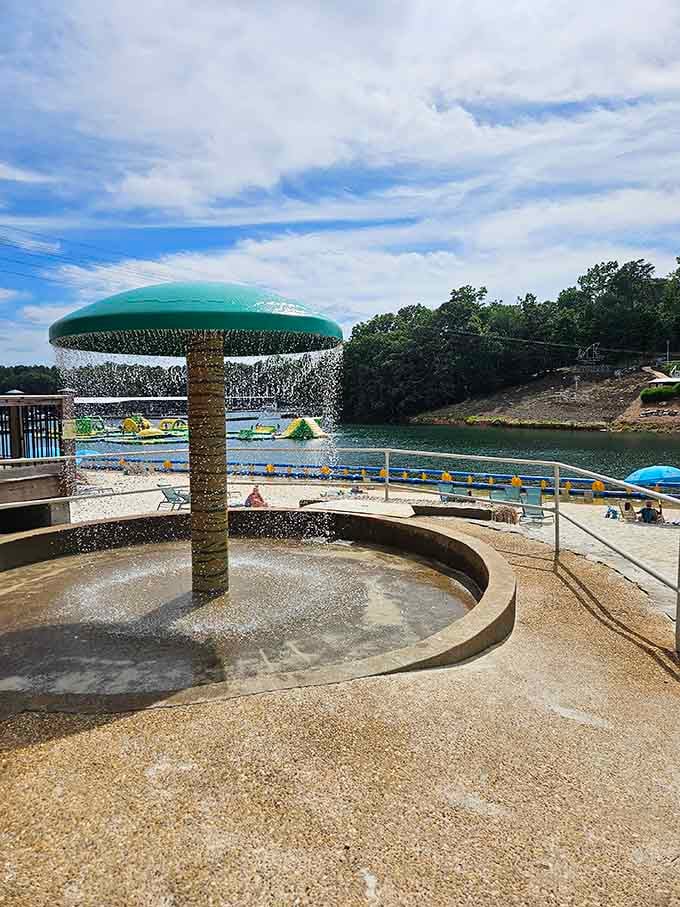 A mushroom fountain doing its cheerful best to cool everyone down, with Lake Lanier sparkling beautifully in the background.