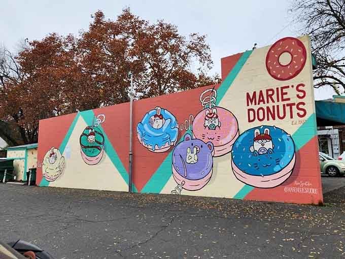 That cheerful mural featuring cartoon donuts is pure joy painted on a wall, Instagram-worthy without even trying.